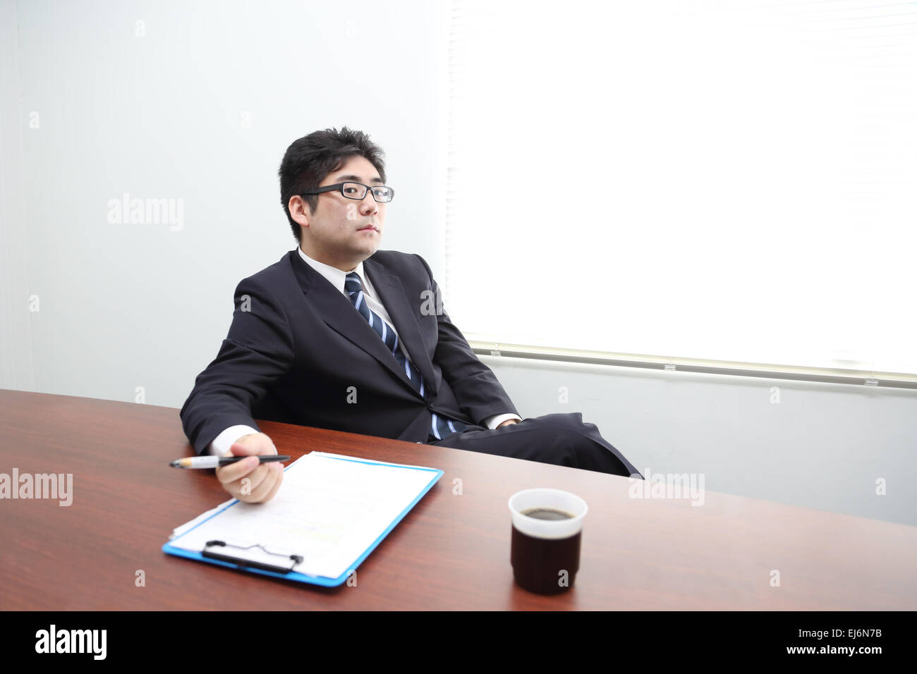 Cross legs desk hi-res stock photography and images - Alamy