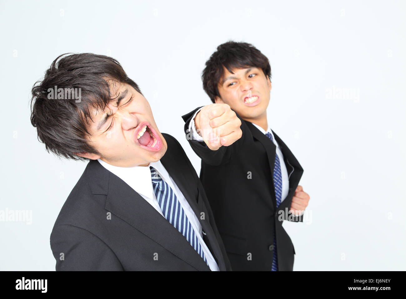 Young Japanese businessmen fighting Stock Photo - Alamy