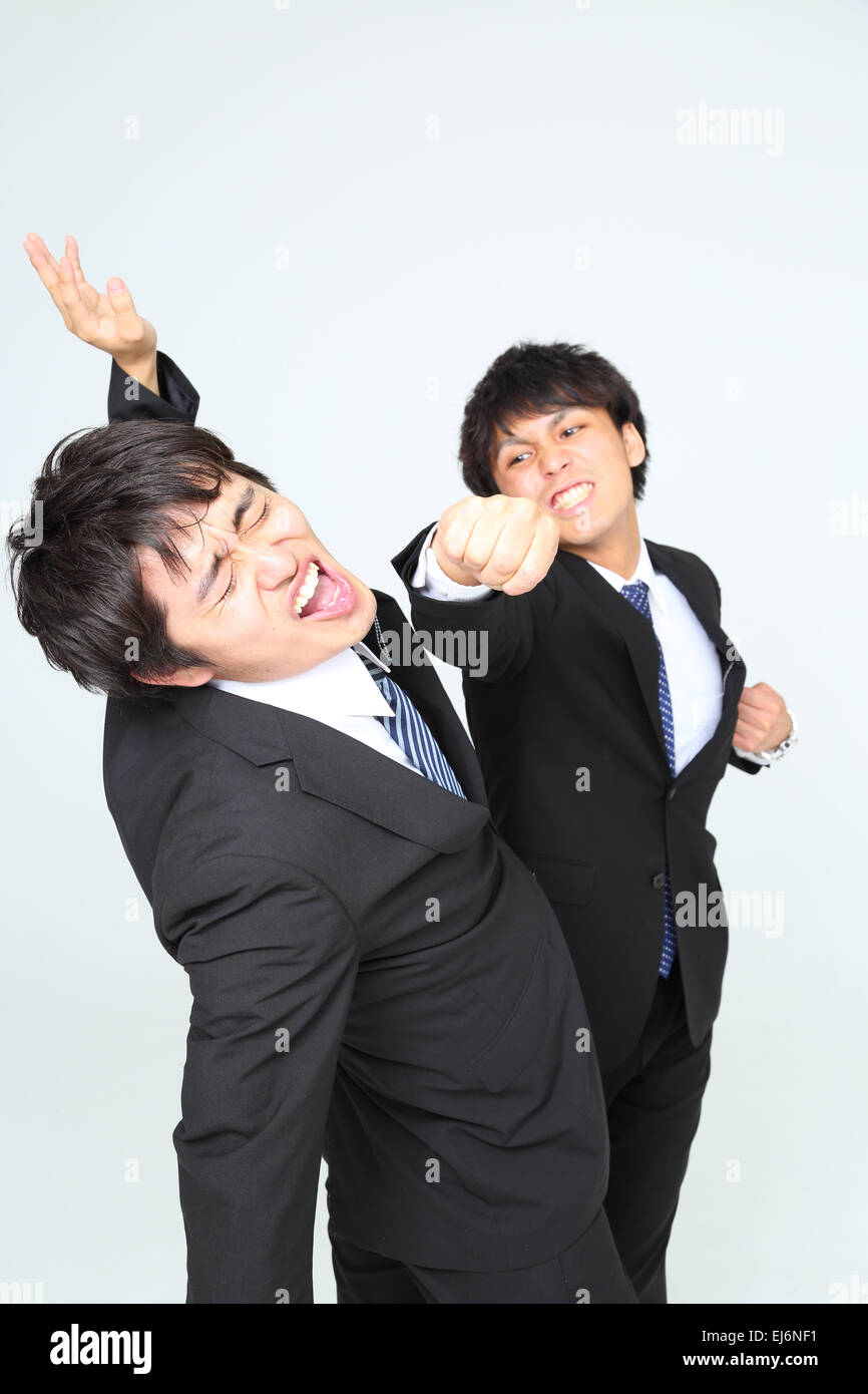 Young Japanese businessmen fighting Stock Photo - Alamy