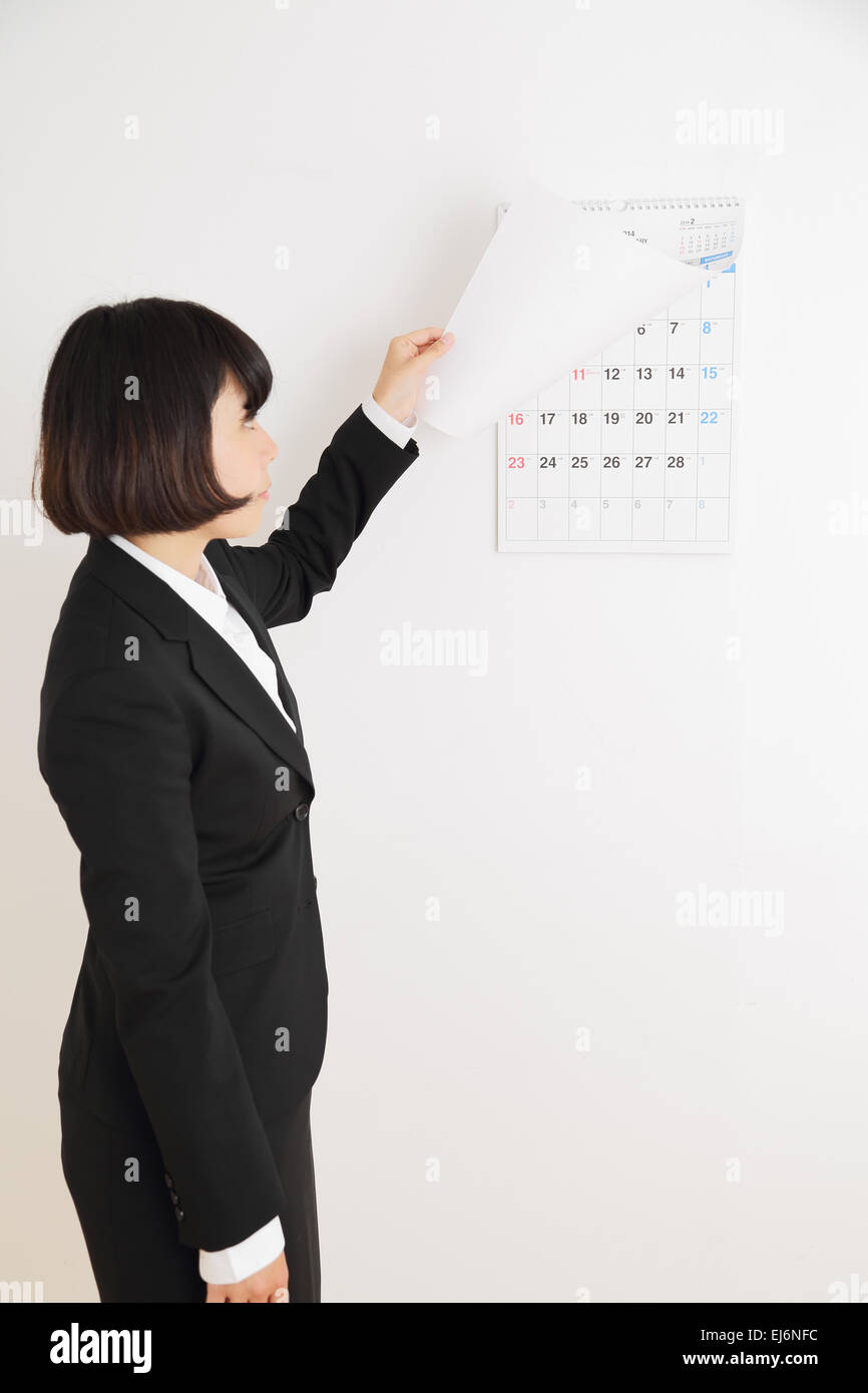 Young Japanese business woman looking at the calendar Stock Photo - Alamy