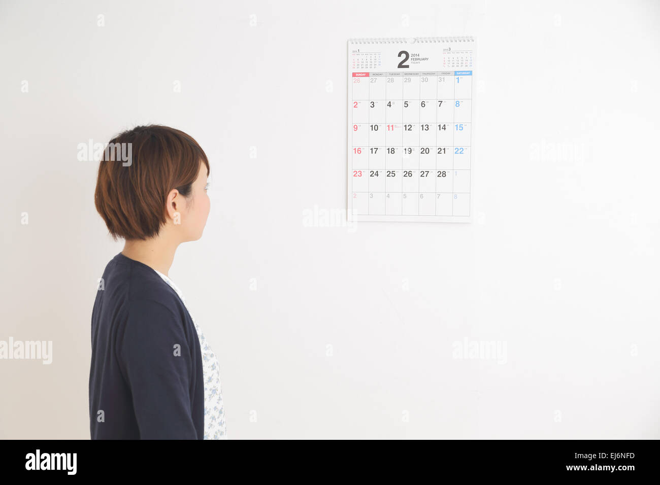 Young Japanese woman looking at the calendar Stock Photo - Alamy