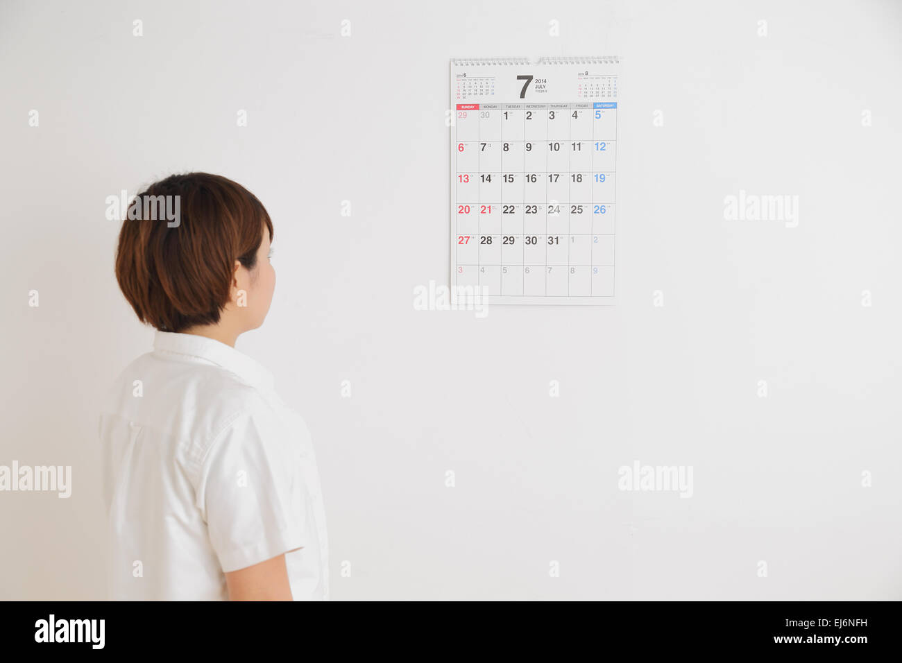 Young Japanese woman looking at the calendar Stock Photo - Alamy