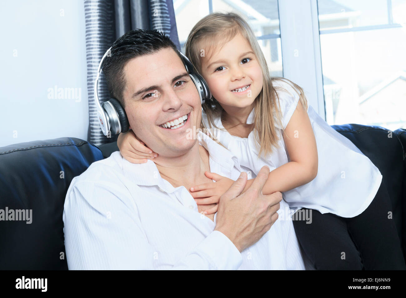 Father and daughter listening to music Stock Photo - Alamy