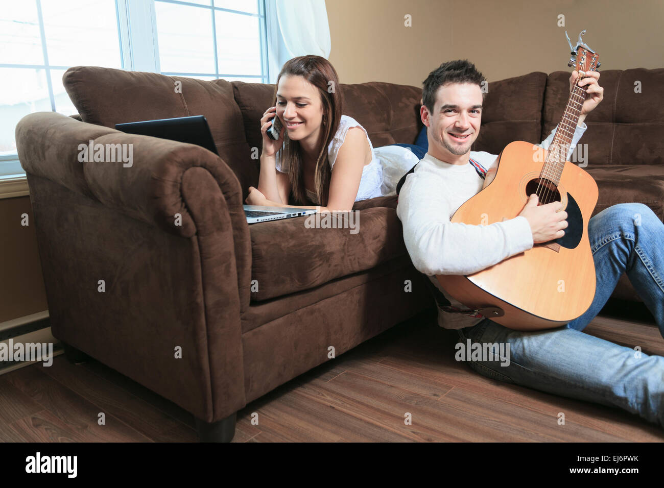 man serenading his girlfriend with guitar at home Stock Photo - Alamy
