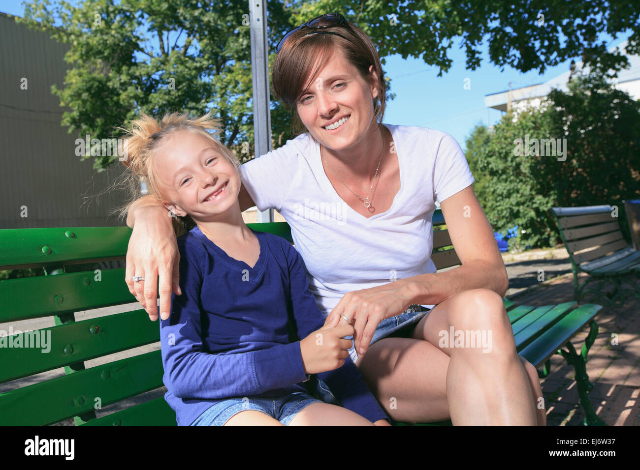 women and little girl sit on bench Stock Photo - Alamy