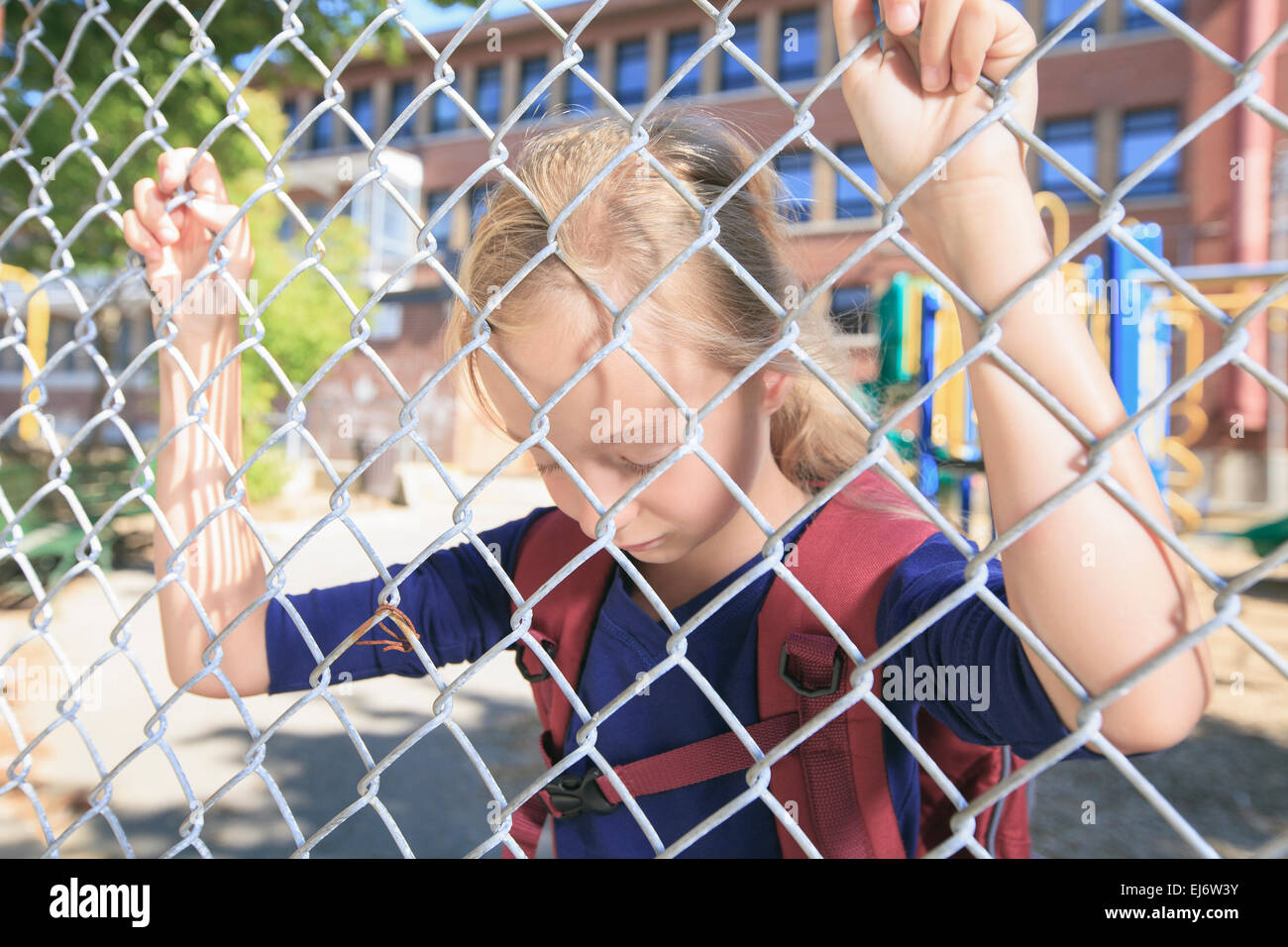 Sad fence girl Stock Photo - Alamy