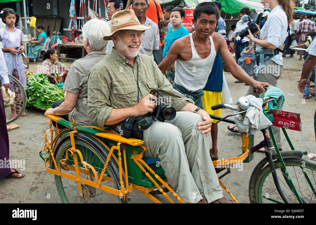Western tourists riding on tricycle at the market, Sittwe, Rakhine ...