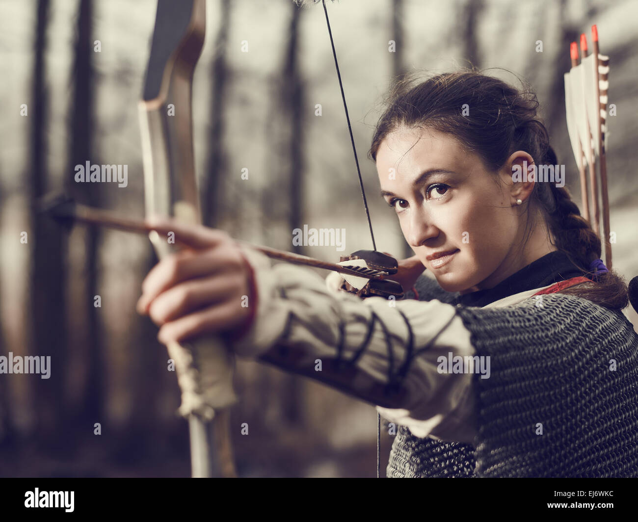 Medieval archer woman, she wearing a chainmail and use a bow and arrow ...