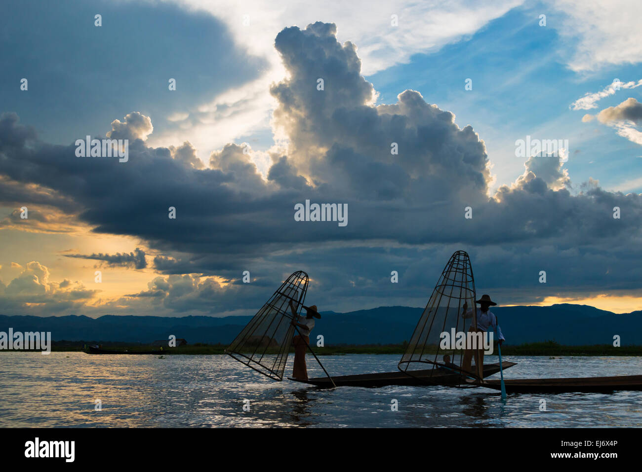 Intha fisherman rowing boat with leg at sunset on Inle Lake, Shan State ...