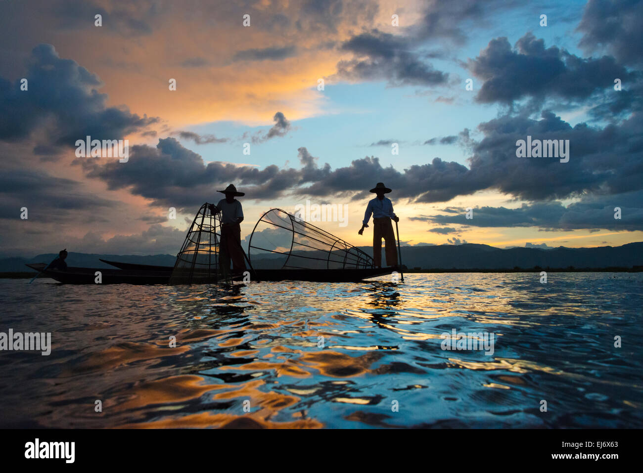 Intha fisherman rowing boat with leg at sunset on Inle Lake, Shan State ...