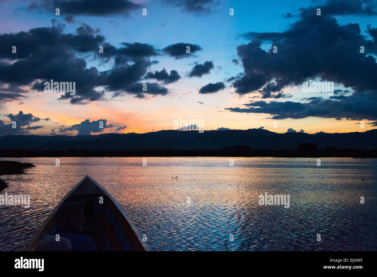 Canoe on Inle Lake at sunset, Shan State, Myanmar Stock Photo - Alamy