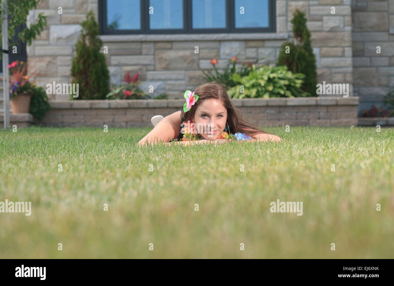 A young woman lay down and take a rest on the green grass Stock Photo ...