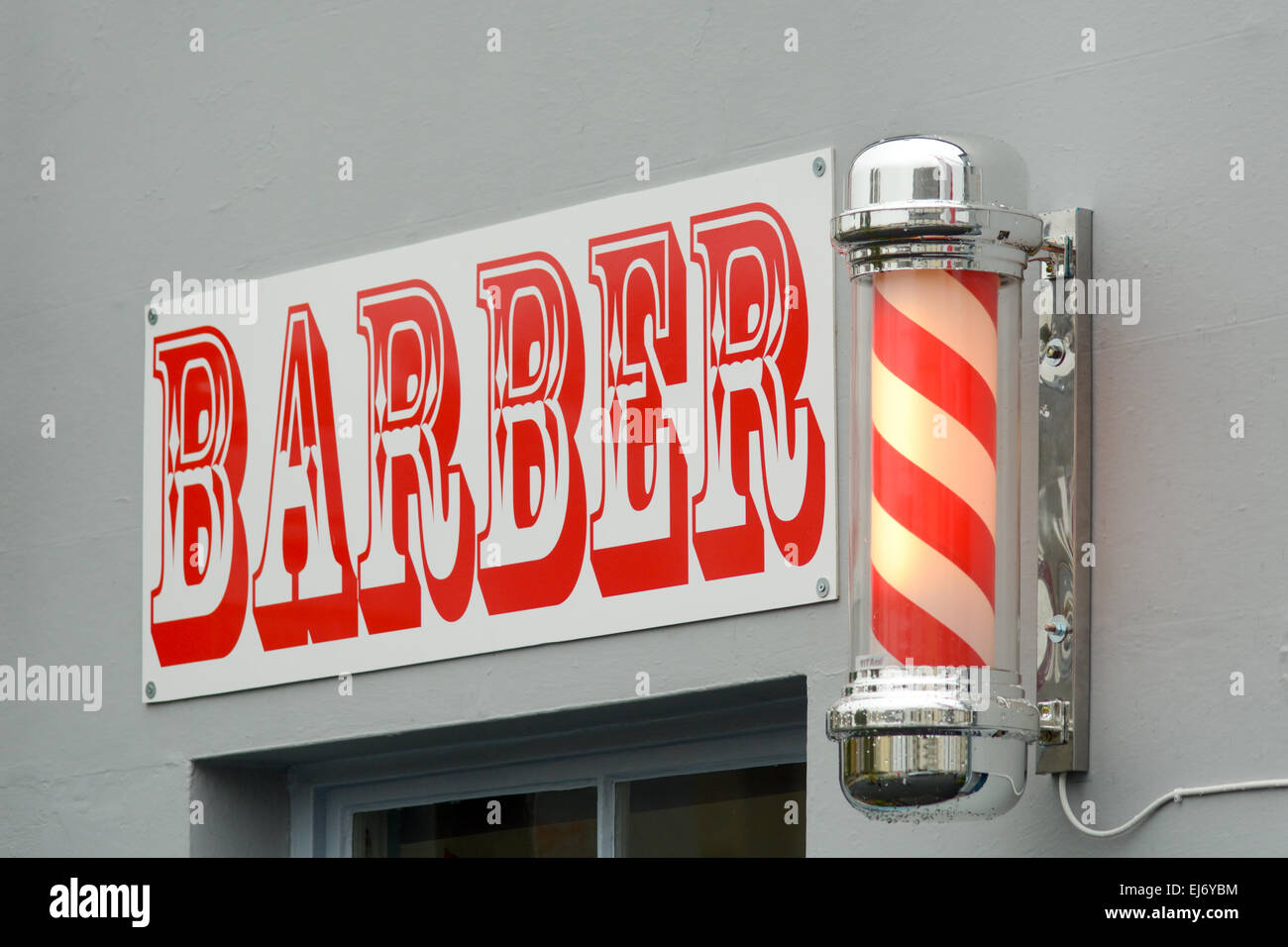 Red and white barber sign and pole outside barbers in Chudleigh, Devon ...