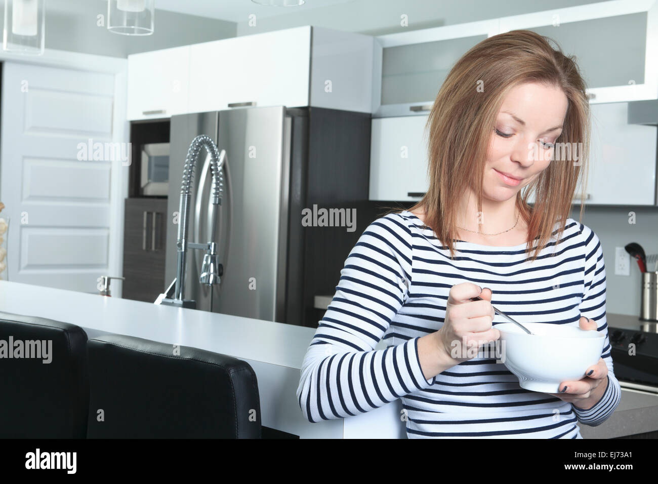 Jolly woman having breakfast at home Stock Photo - Alamy