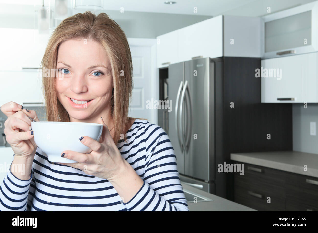 Jolly woman having breakfast at home Stock Photo - Alamy
