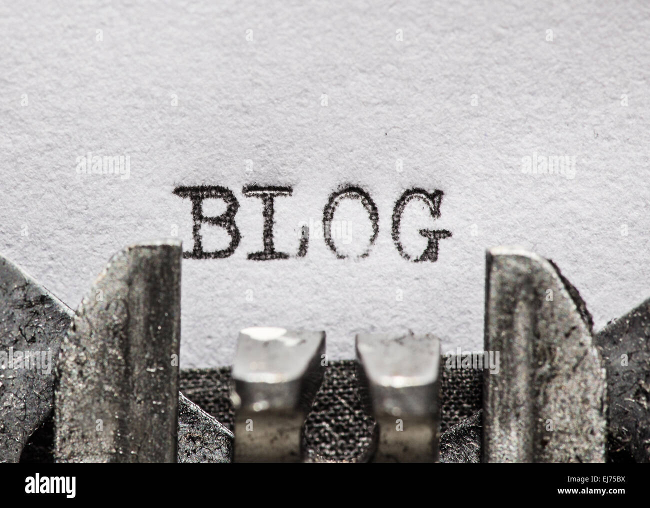 Typewriter with white paper page on wooden table. sample text Blog ...