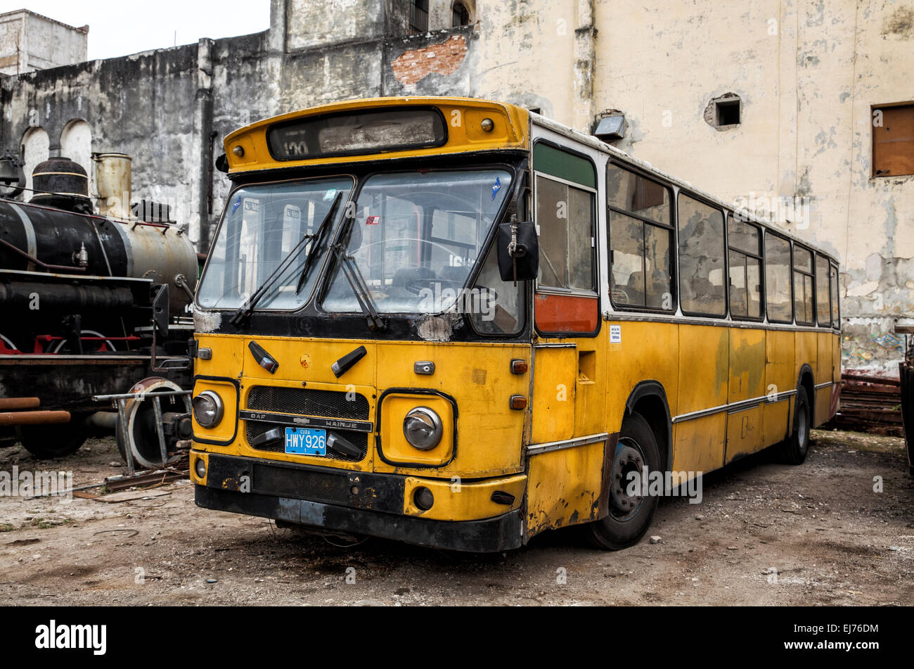 Old American yellow school bus and in the background part of an old ...