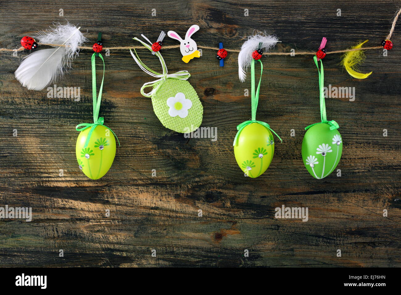 Easter eggs and feathers hanging on a rope Stock Photo - Alamy