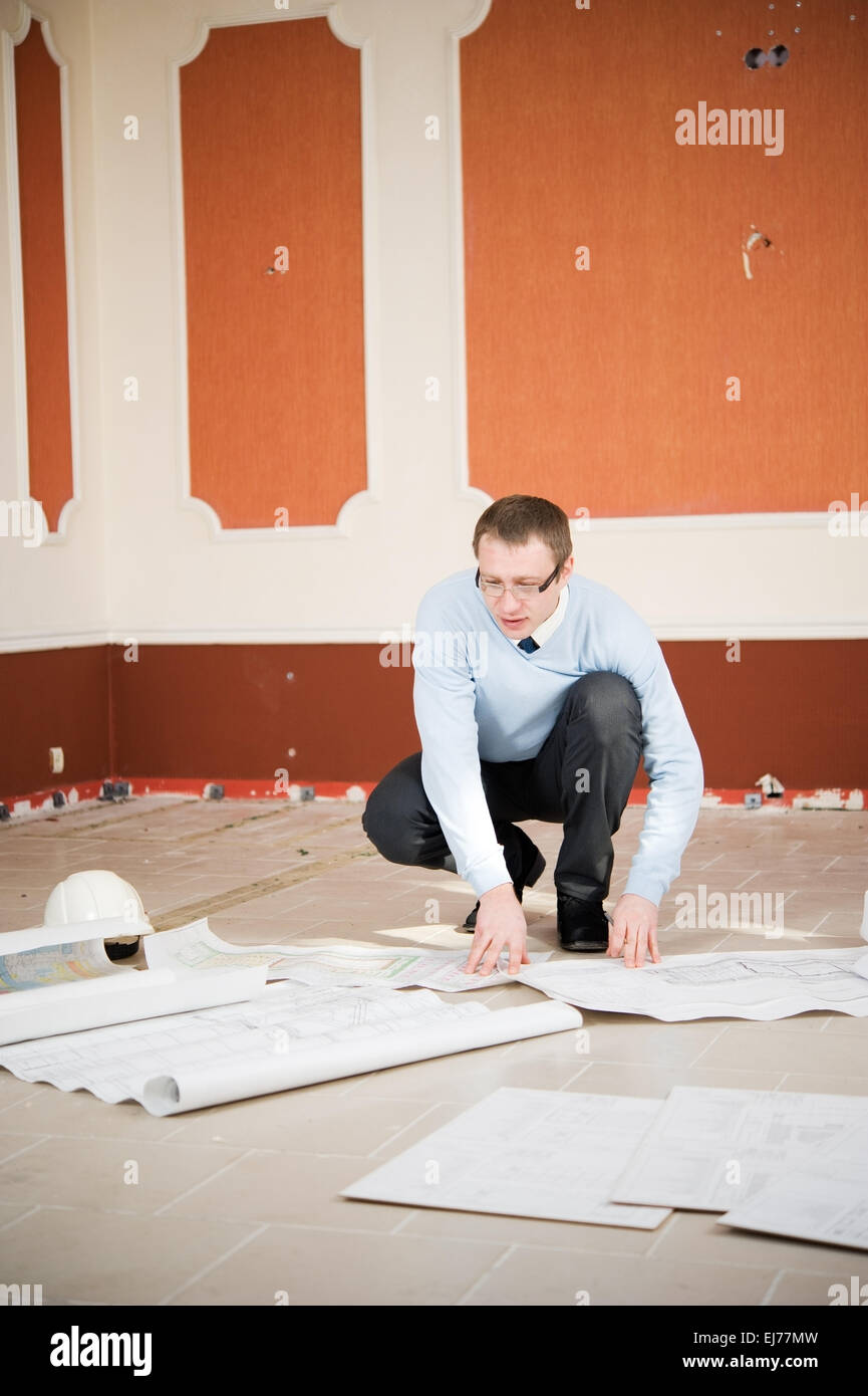 Engineer with plans Stock Photo - Alamy