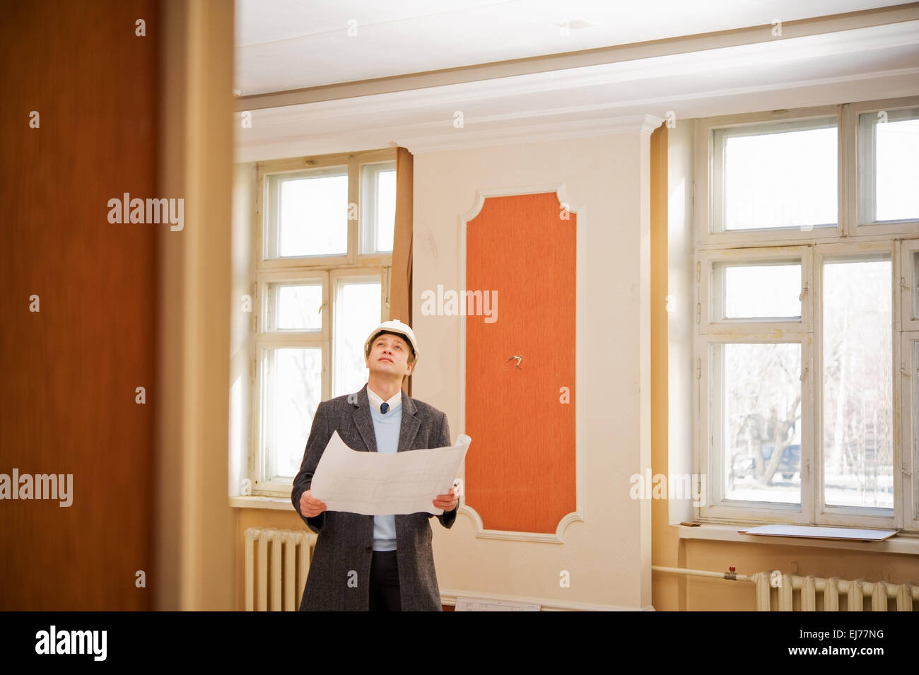 Engineer with plans Stock Photo - Alamy