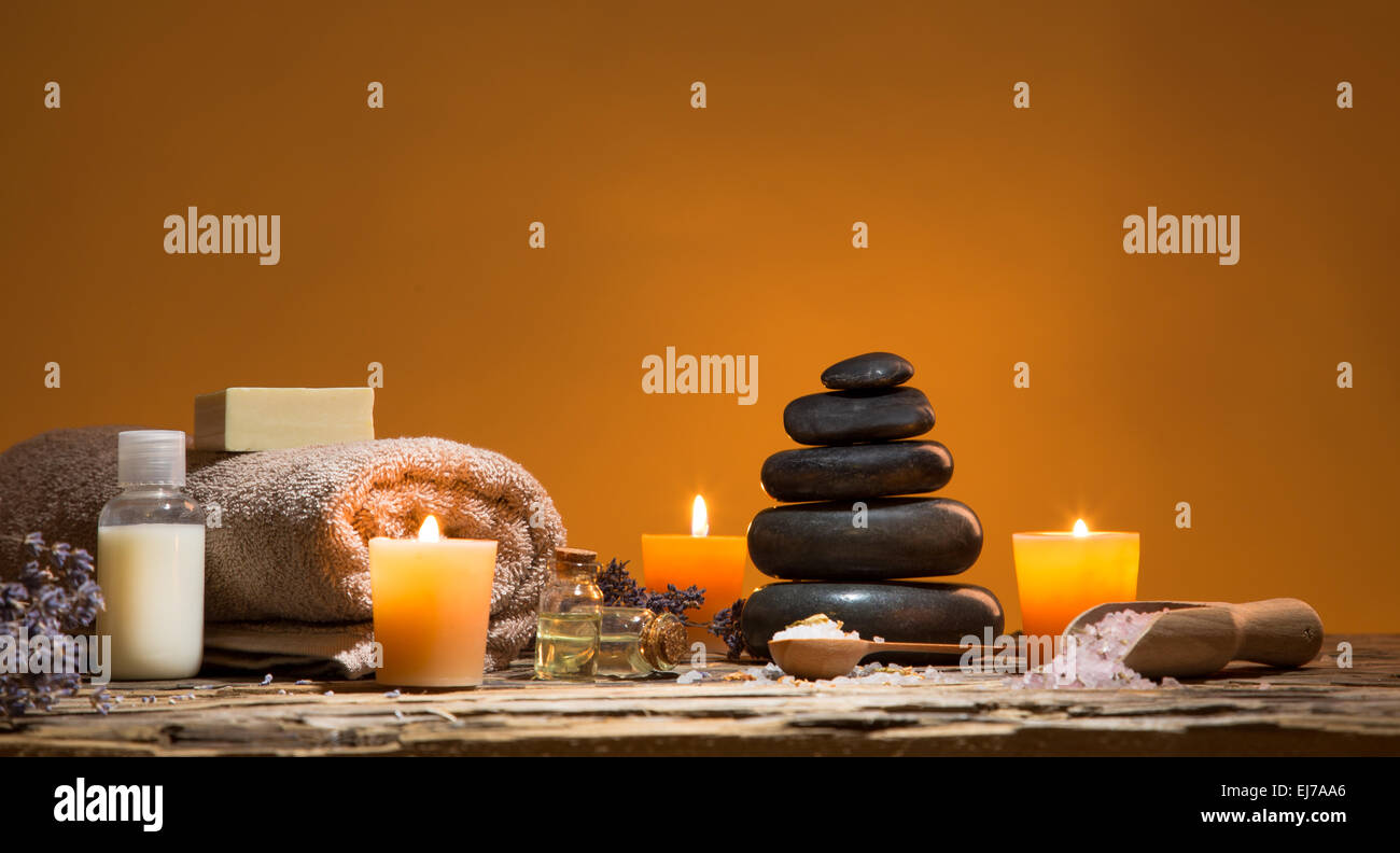 Spa still-life with stacked of stone and burning candles, close-up ...