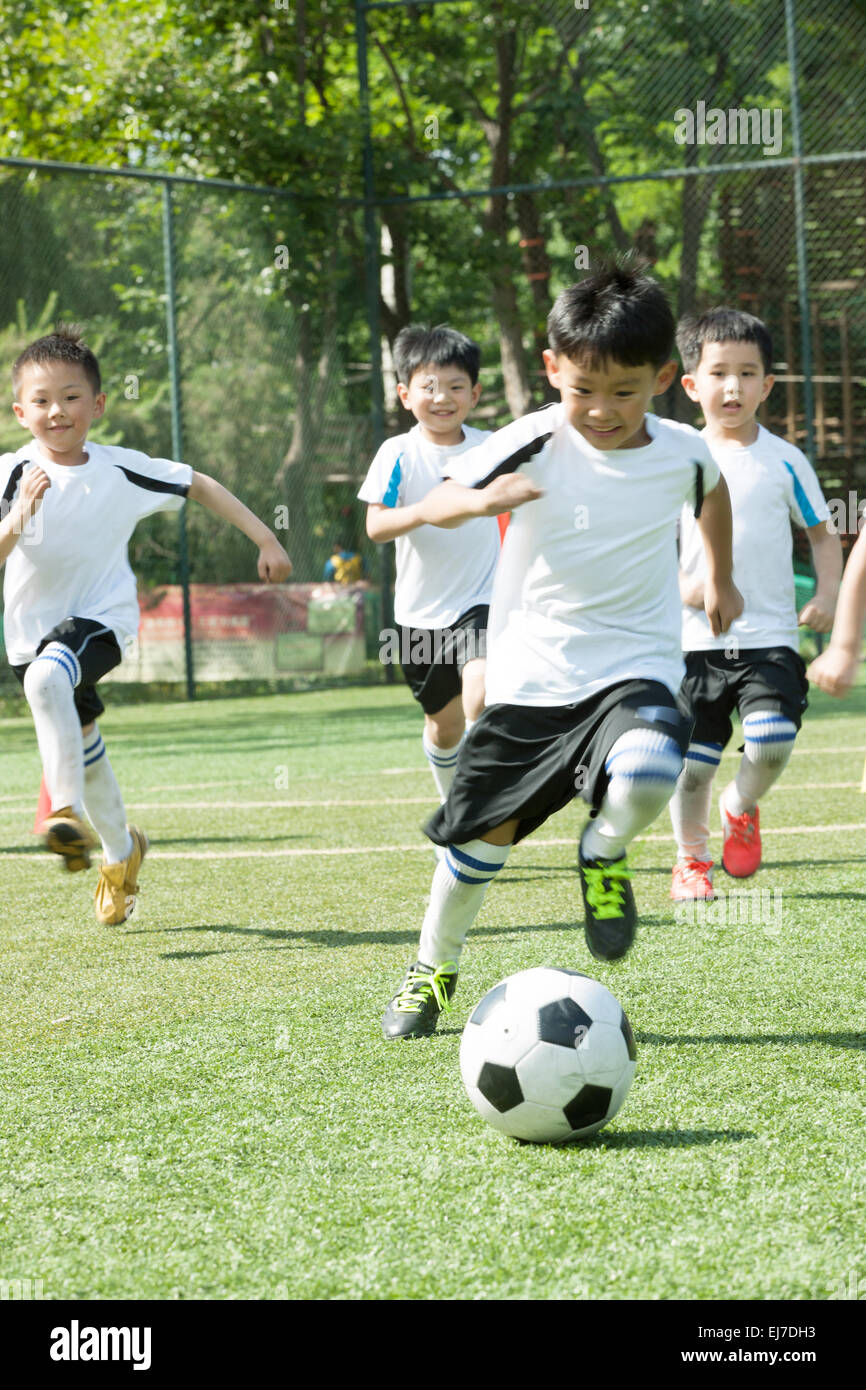 The boys playing football on the playground Stock Photo - Alamy