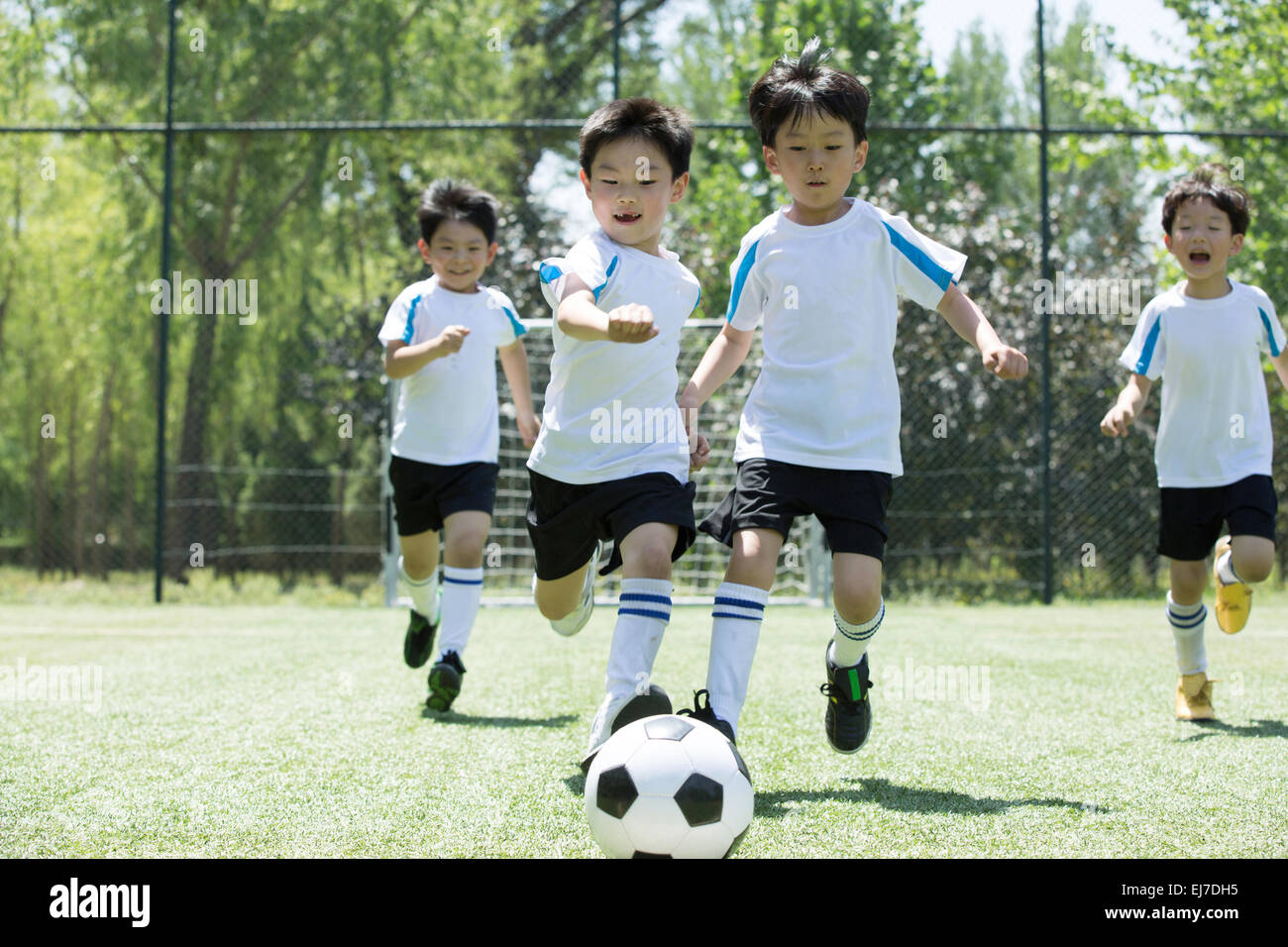 The boys playing football on the playground Stock Photo - Alamy