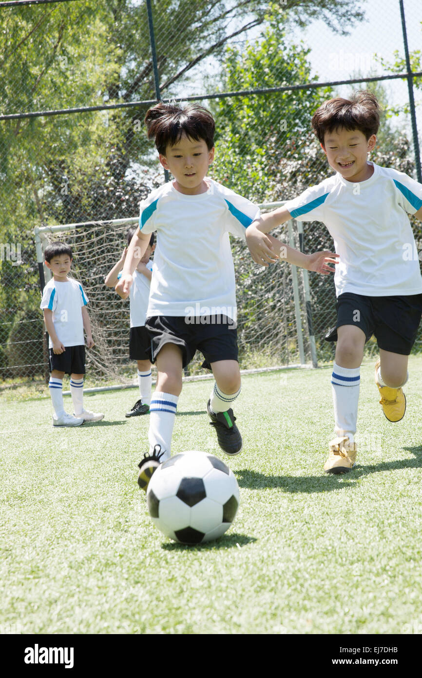 The boys playing football on the playground Stock Photo - Alamy