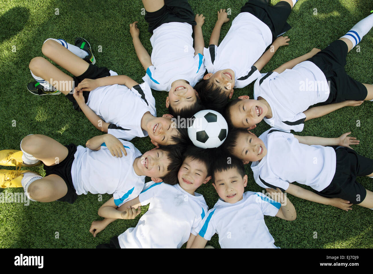 The children gathered to form a round lie on the football field Stock ...