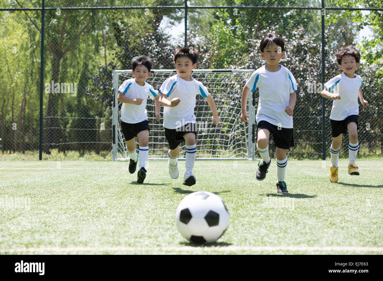 The boys playing football on the playground Stock Photo - Alamy
