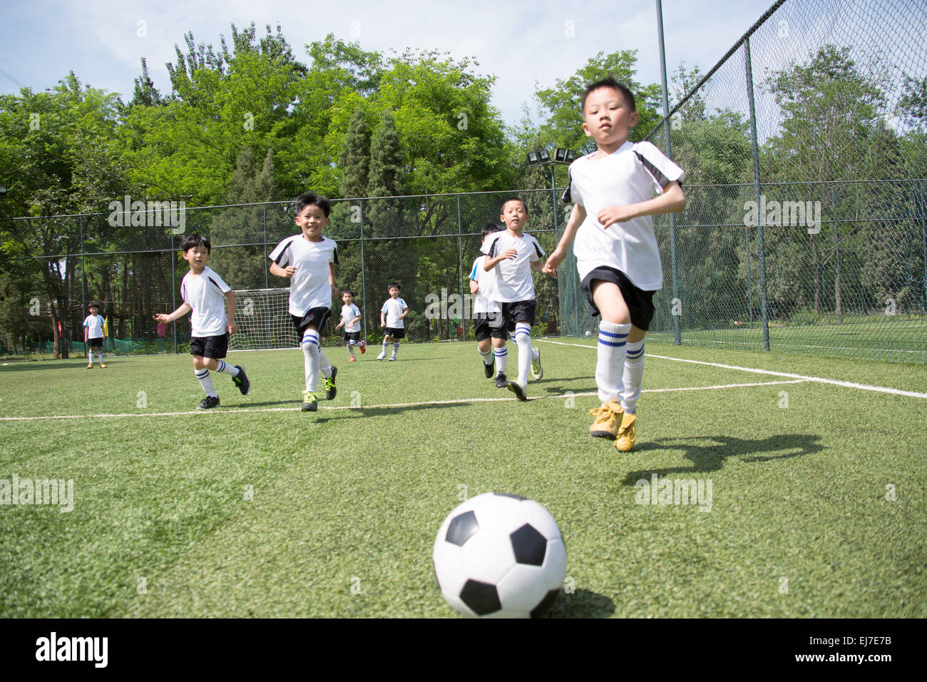 The boys playing football on the playground Stock Photo - Alamy