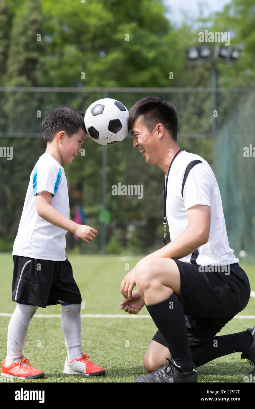 The boy and The coach face to face with football Stock Photo - Alamy