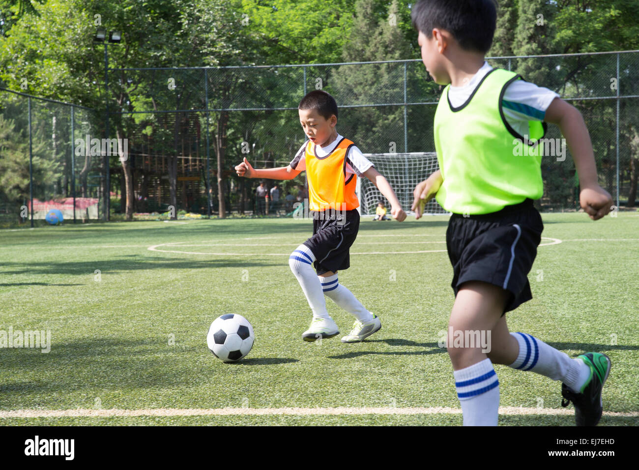 The boy playing football on the football field Stock Photo - Alamy