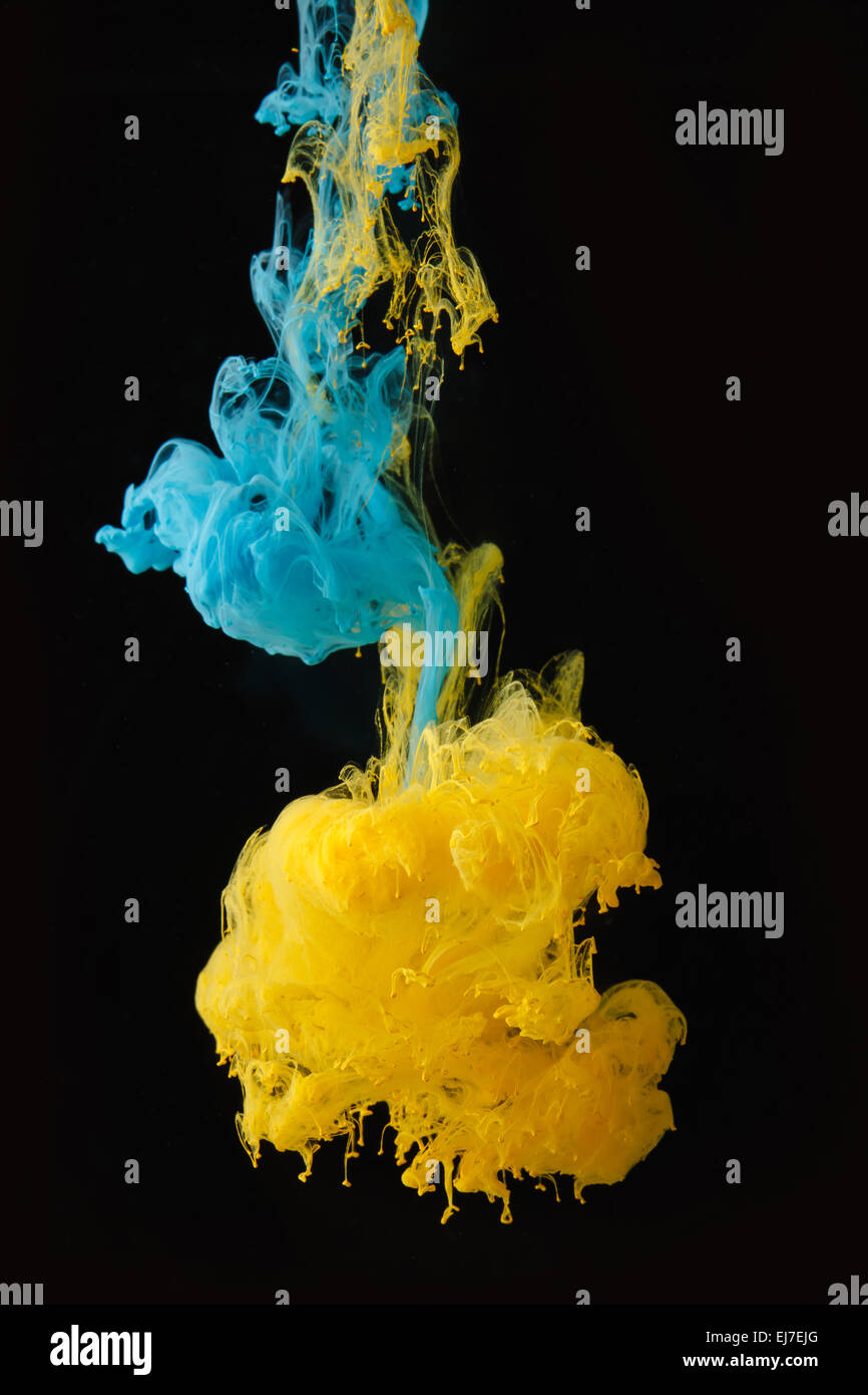 Blue and yellow ink in the water Stock Photo - Alamy