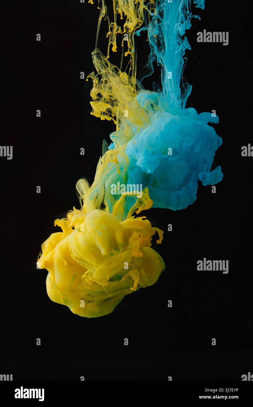 Blue and yellow ink in the water Stock Photo - Alamy