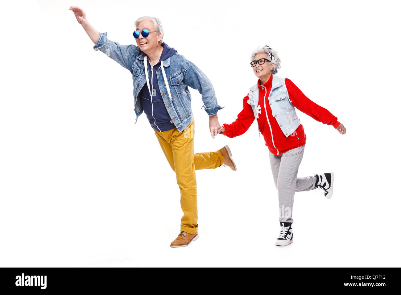 Elderly couple run hand in hand Stock Photo - Alamy