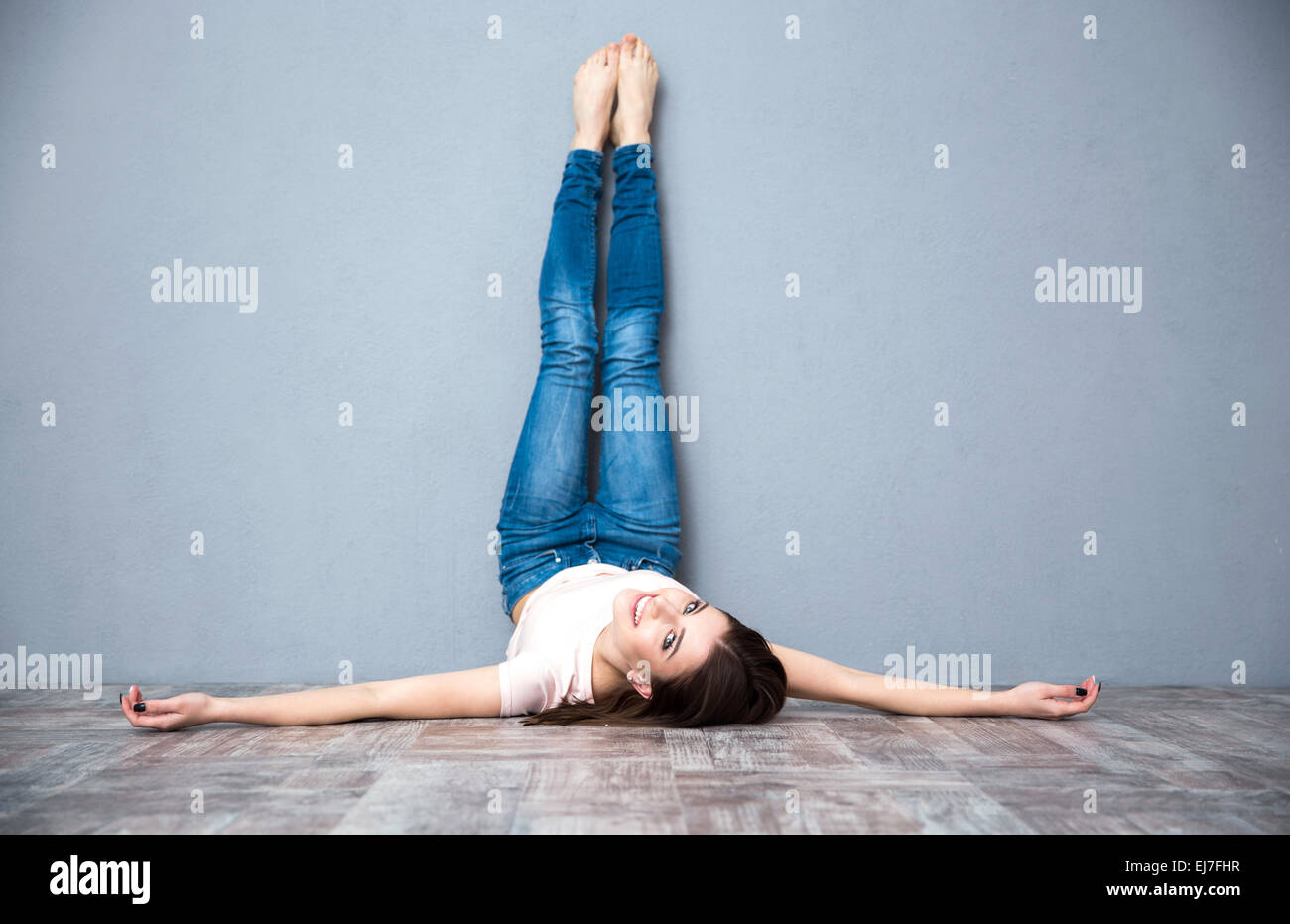 Young woman lying on wall hi-res stock photography and images - Alamy