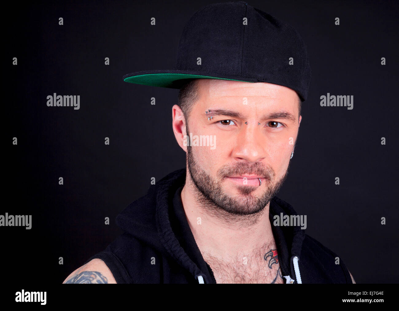 A Urban man wearing baseball cap over black background studio Stock ...