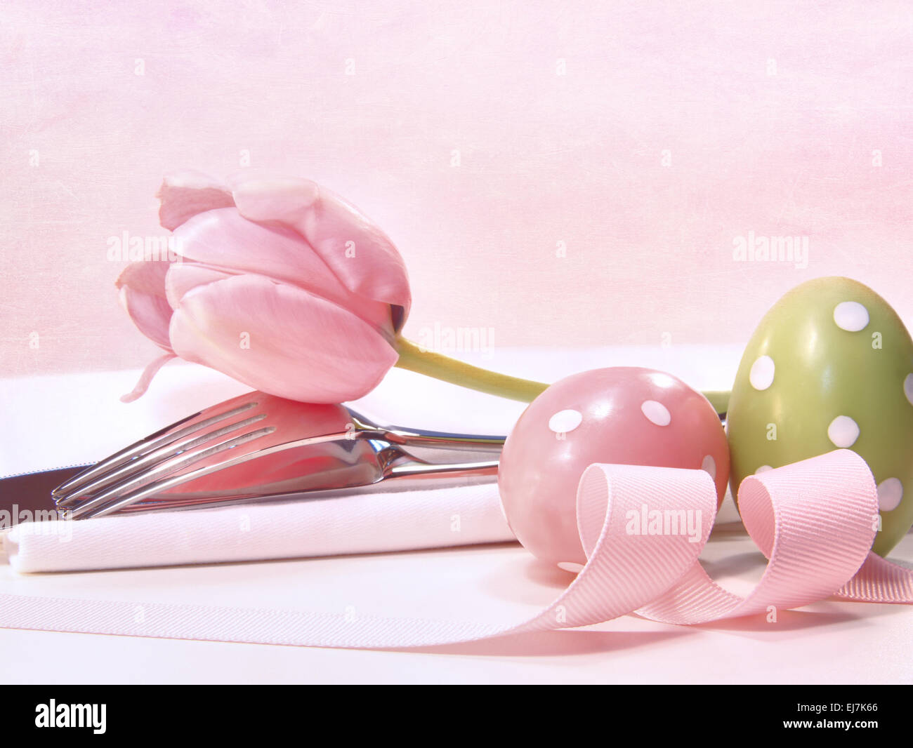 Closeup of utensils and pink tulip Stock Photo - Alamy