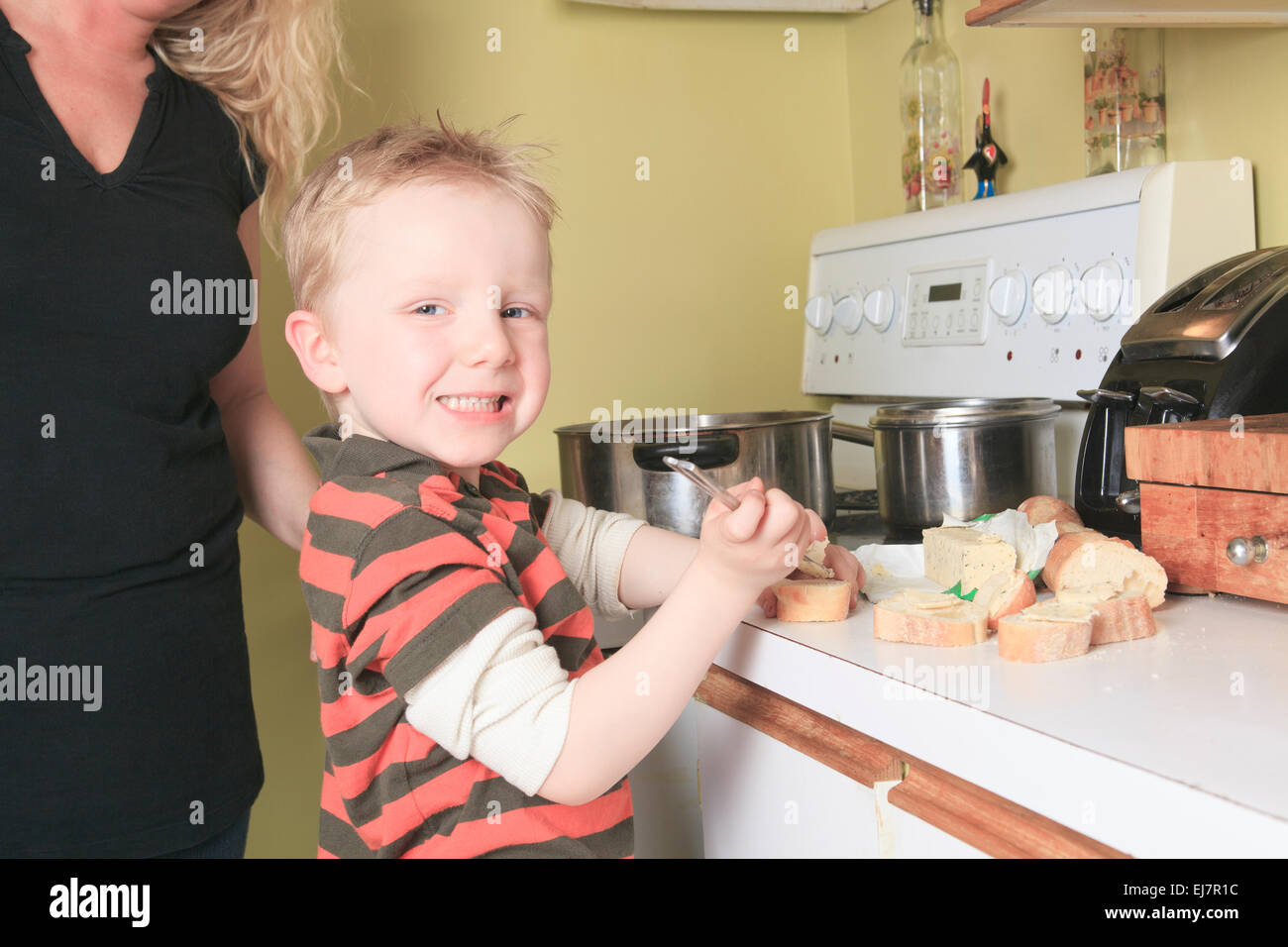 Family cooking in their kitchen - mother making some bread Stock Photo ...
