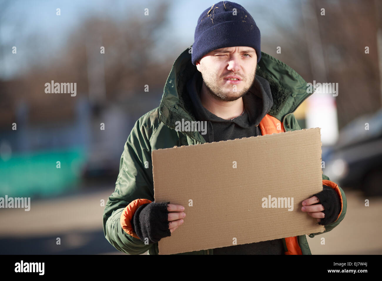 Homeless man holds blank cardboard for your own text Stock Photo - Alamy
