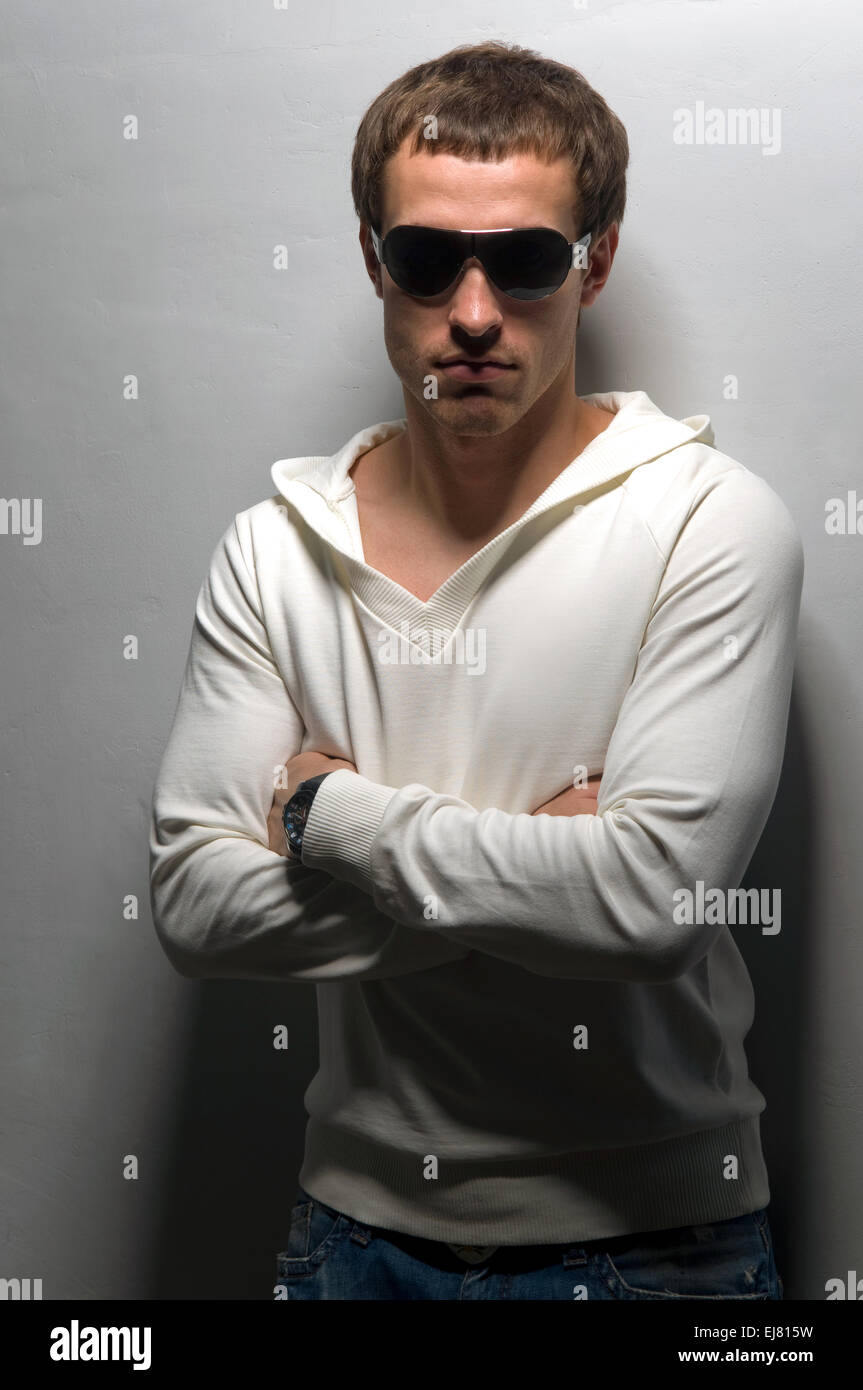 man standing near a wall Stock Photo - Alamy