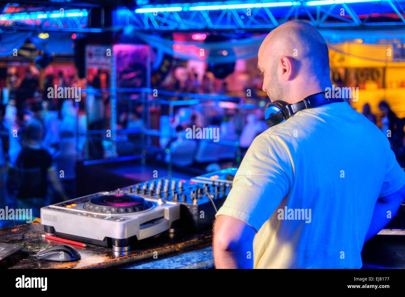 DJ behind the control panel Stock Photo - Alamy