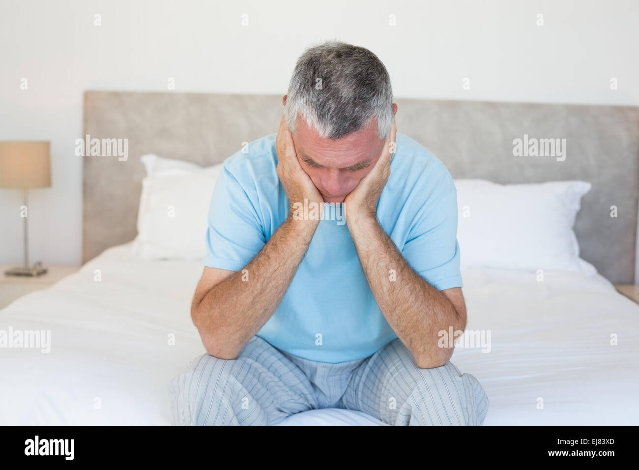 Sad senior man on bed Stock Photo - Alamy
