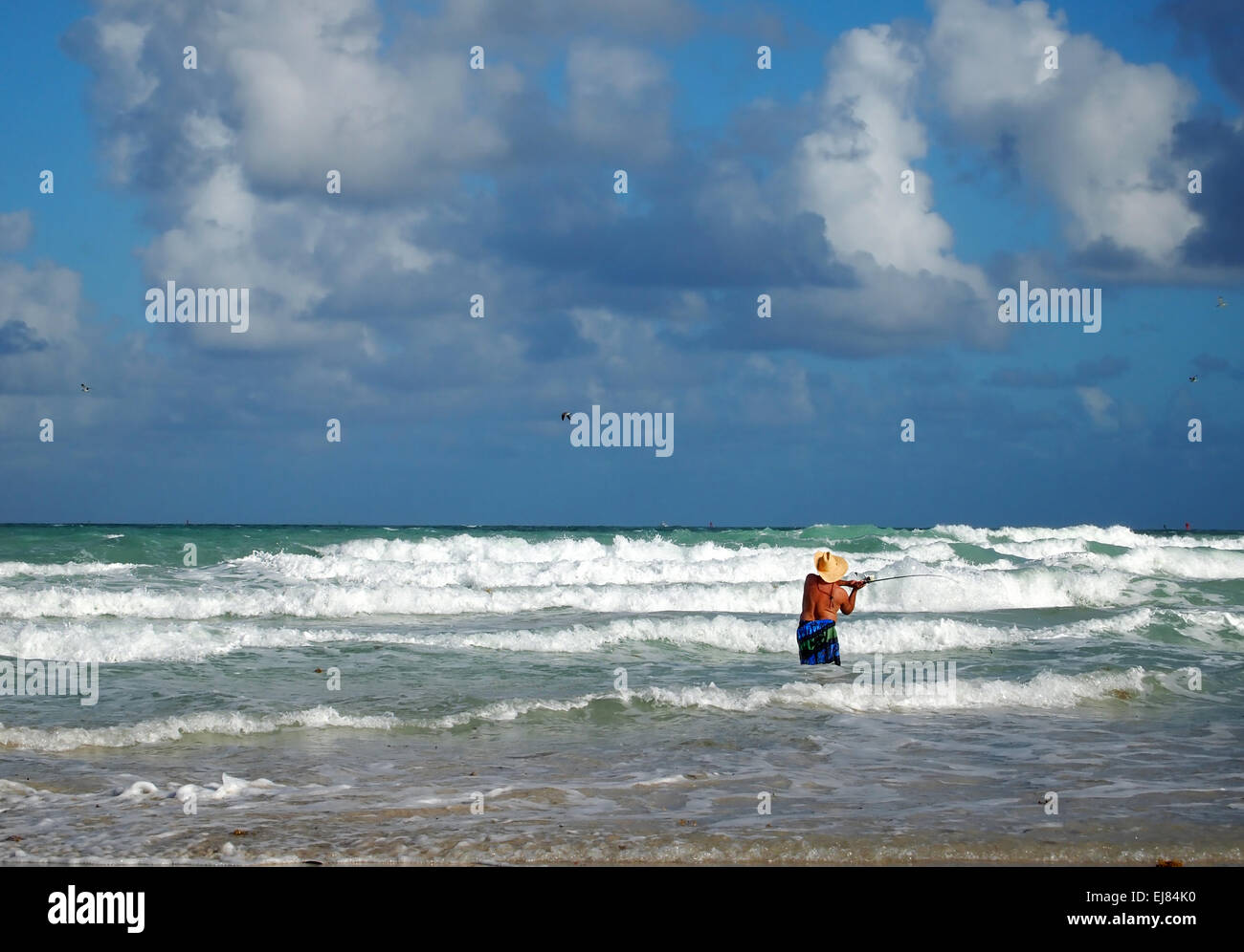 Man on beach with fishing pole hi-res stock photography and images - Alamy
