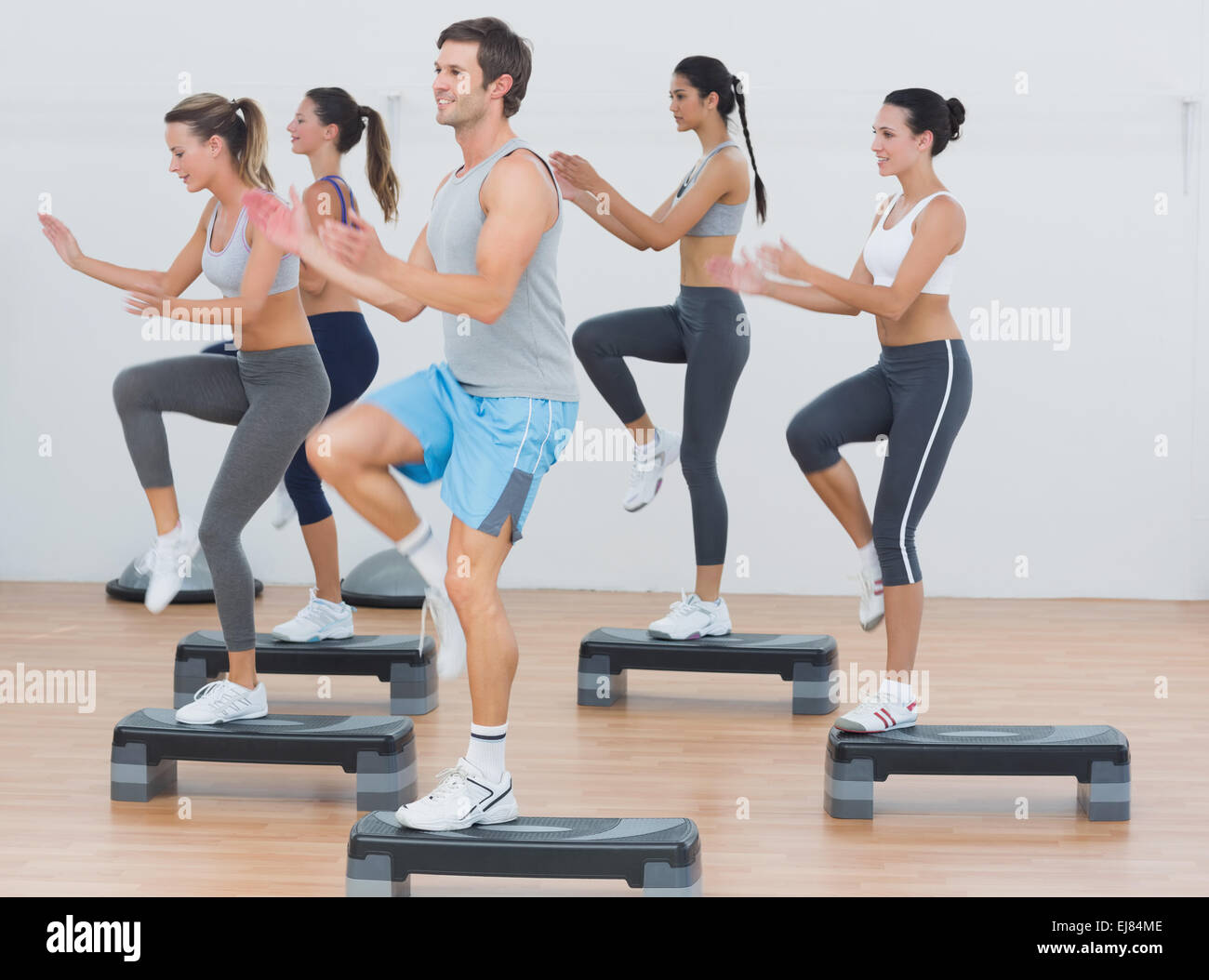 Fitness class performing step aerobics exercise Stock Photo - Alamy