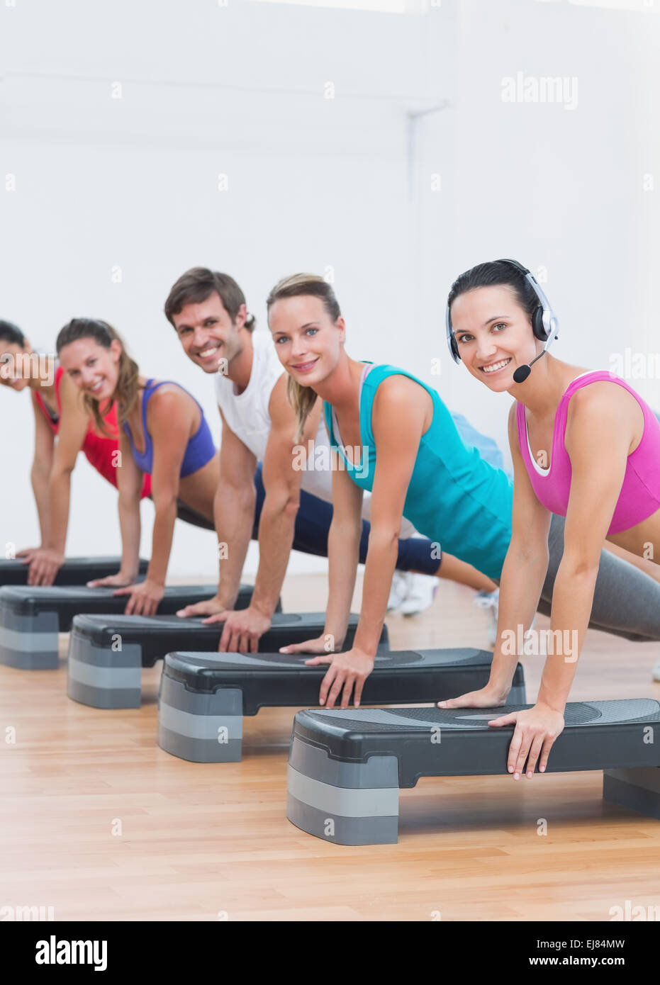 Fitness class doing step aerobics exercise Stock Photo - Alamy