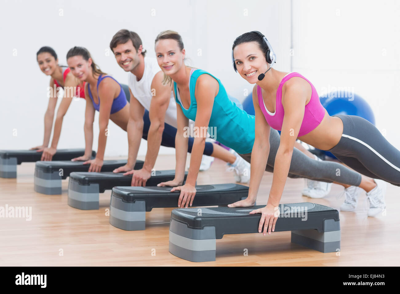 Fitness class doing step aerobics exercise Stock Photo - Alamy