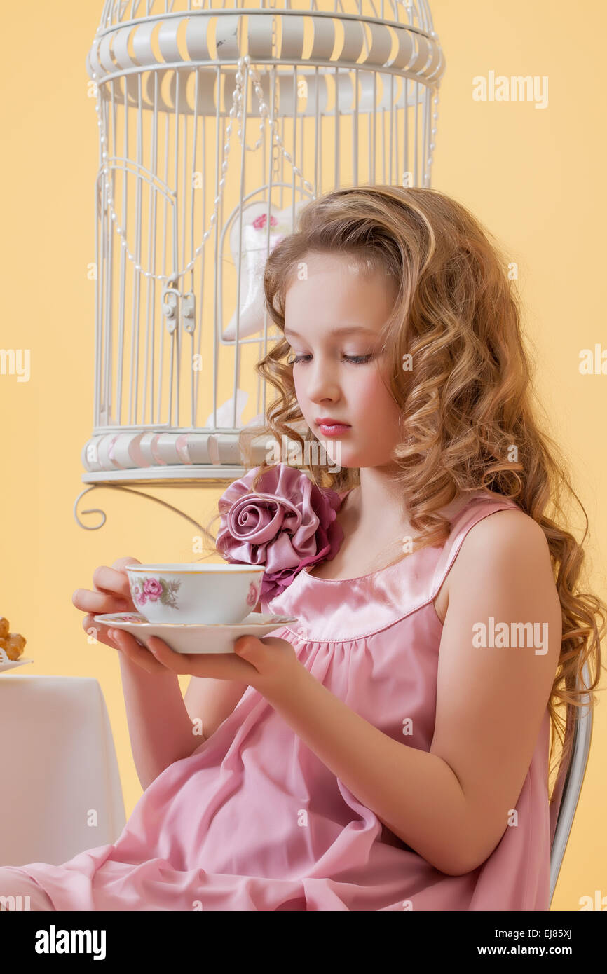 Portrait of pretty curly girl drinking tea Stock Photo - Alamy