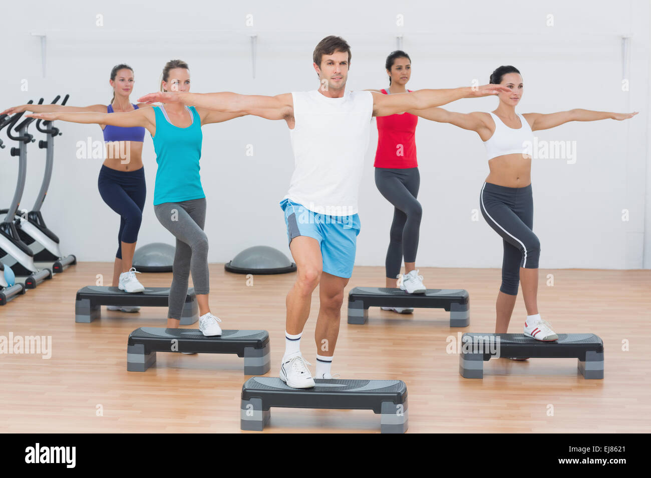 Fitness class performing step aerobics exercise Stock Photo - Alamy